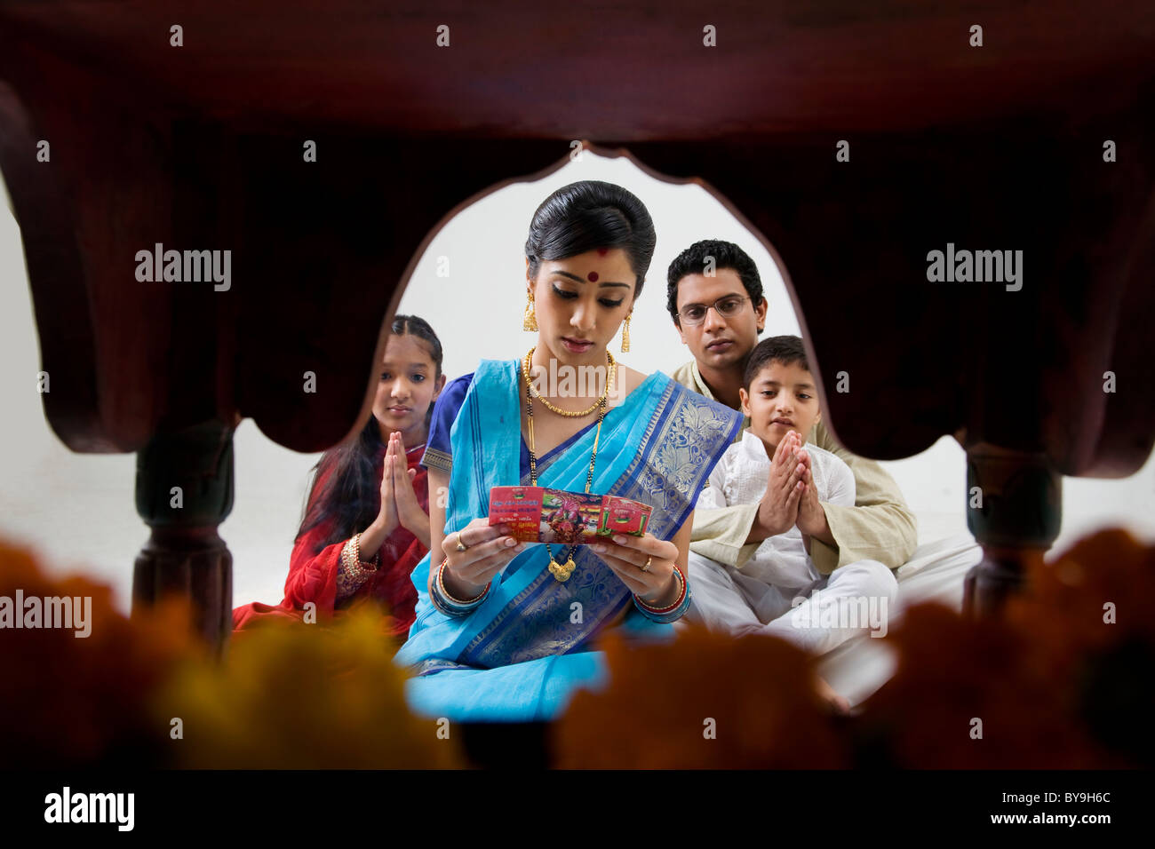Bengali family performing a puja Stock Photo - Alamy