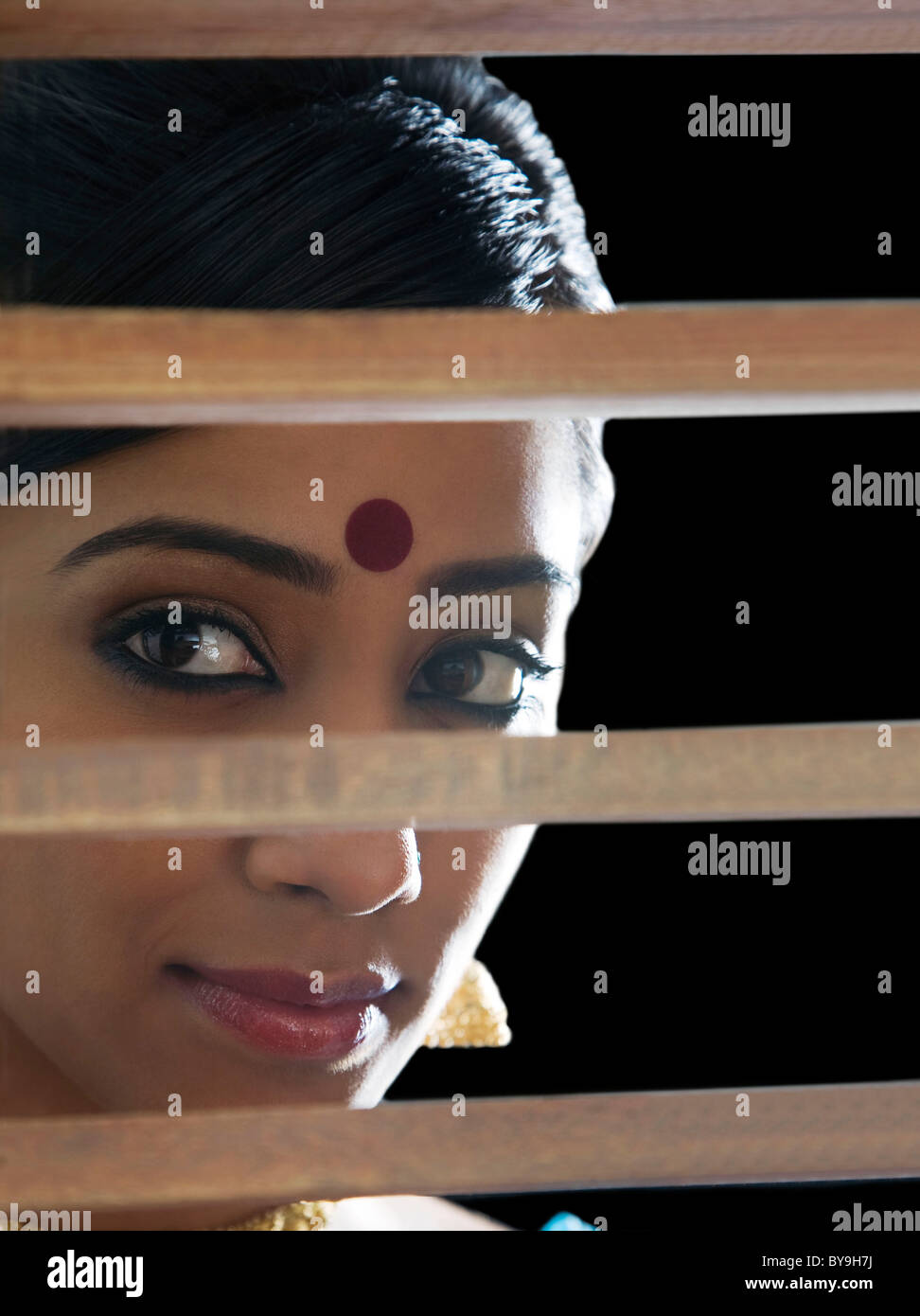 Bengali woman looking through a window Stock Photo - Alamy