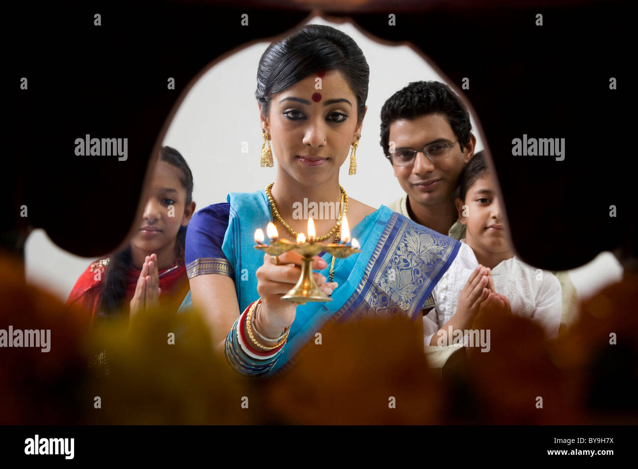 Bengali family performing a puja Stock Photo - Alamy