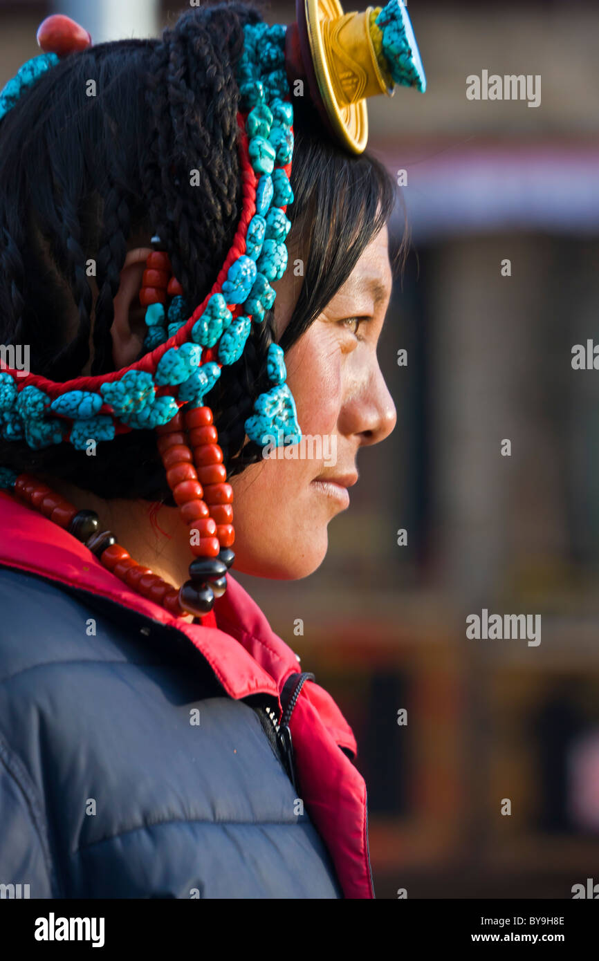 Tibetan woman with beads in her hair in the Barkhor Lhasa Tibet ...