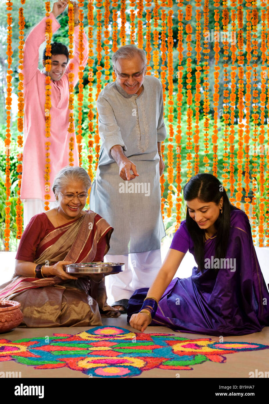 Woman making a rangoli Stock Photo - Alamy