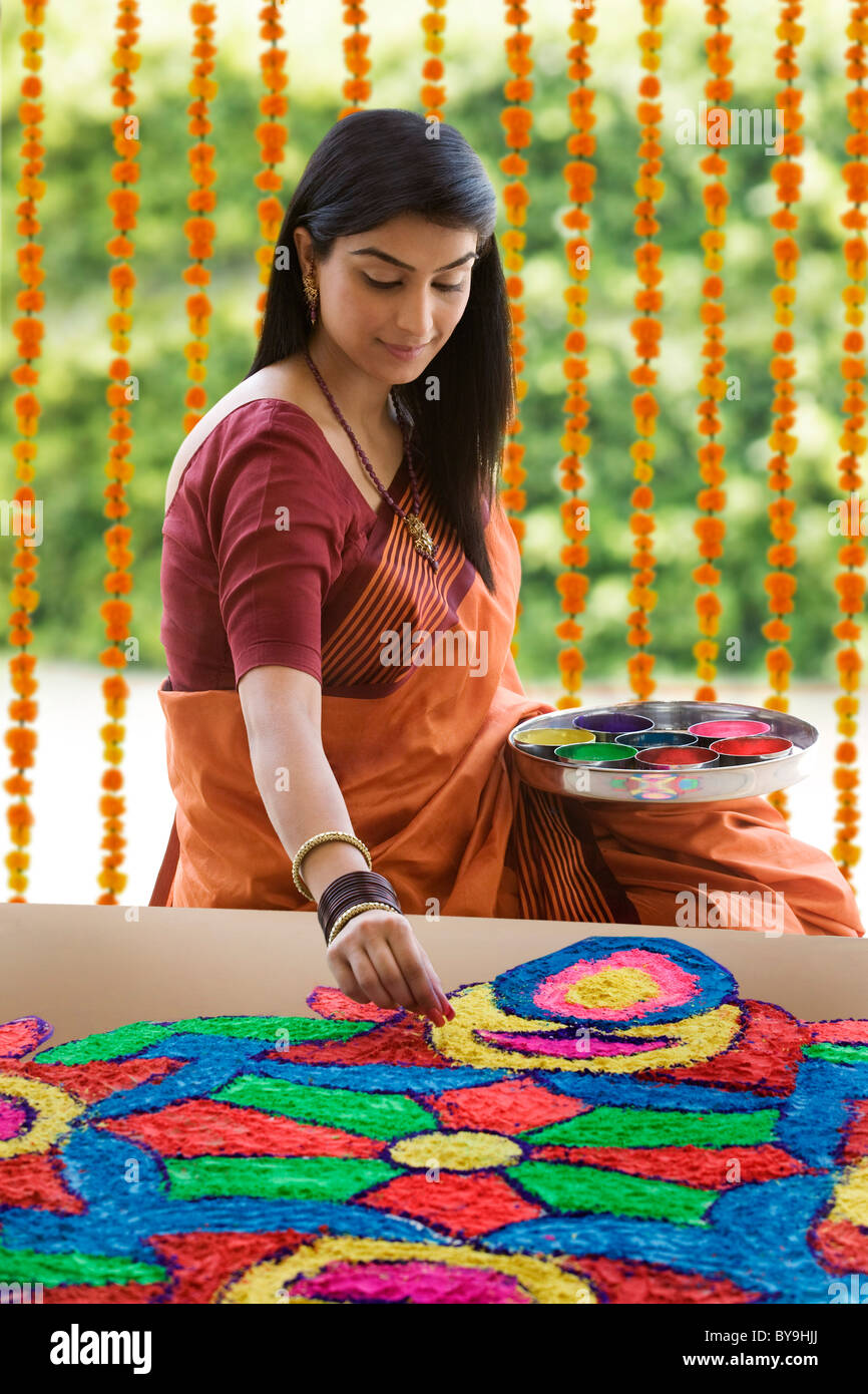 Woman making a rangoli Stock Photo - Alamy