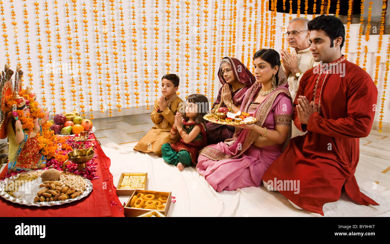 Family doing a pooja Stock Photo - Alamy