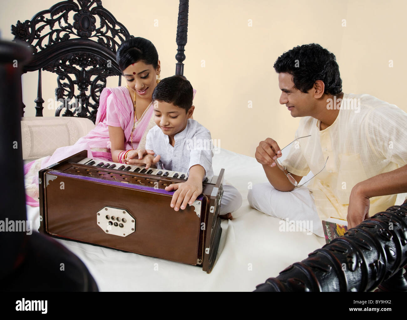 Boy playing on a harmonium Stock Photo - Alamy