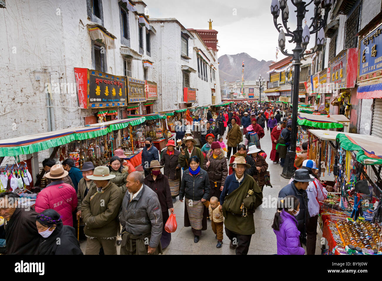 Tibetan pilgrims circumambulating the Barkhor in Lhasa Tibet in a ...