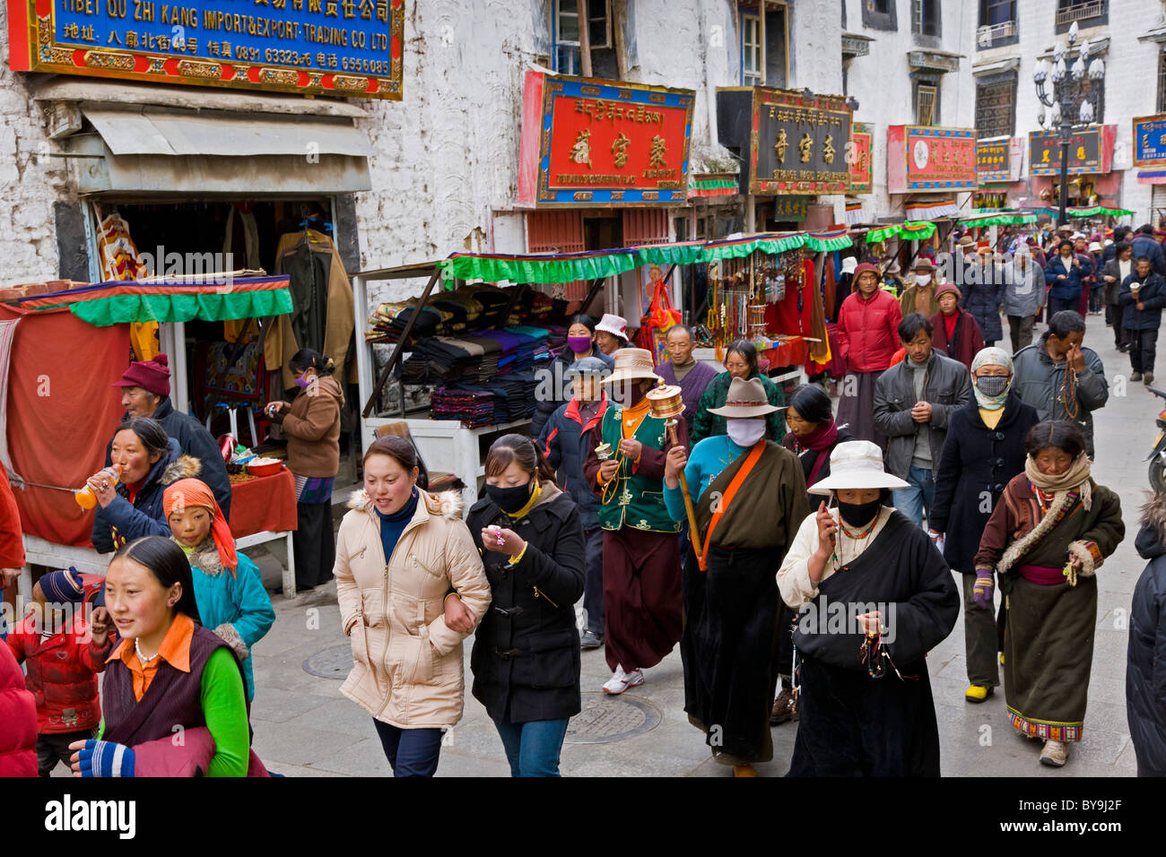 Tibetan pilgrims circumambulating the Barkhor in Lhasa Tibet in a ...