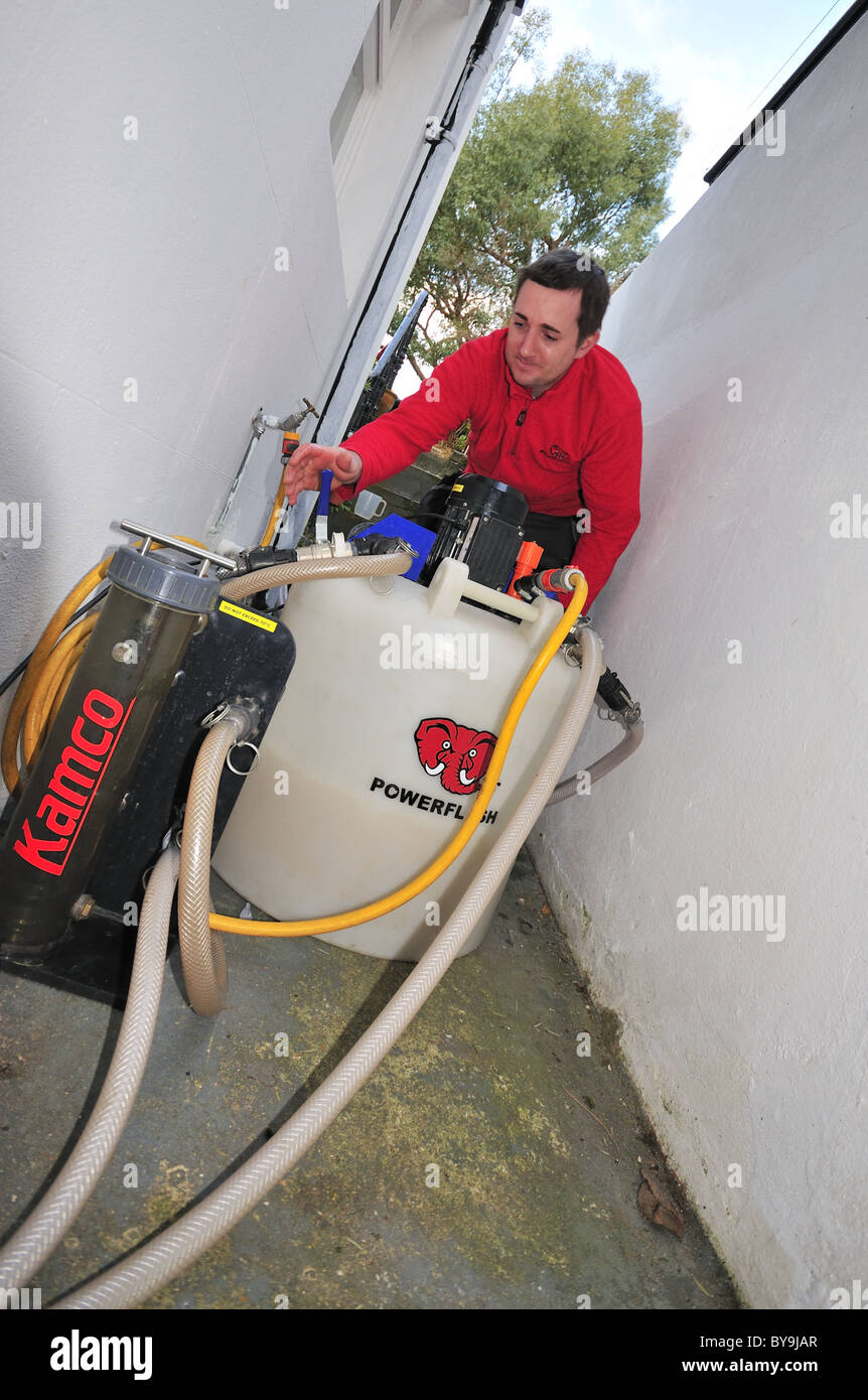 Service engineer ,using power flushing equipment for cleaning the ...