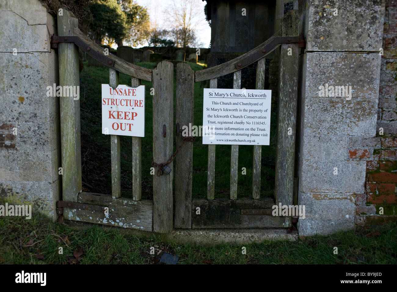 warning signs on disused church gate Stock Photo - Alamy