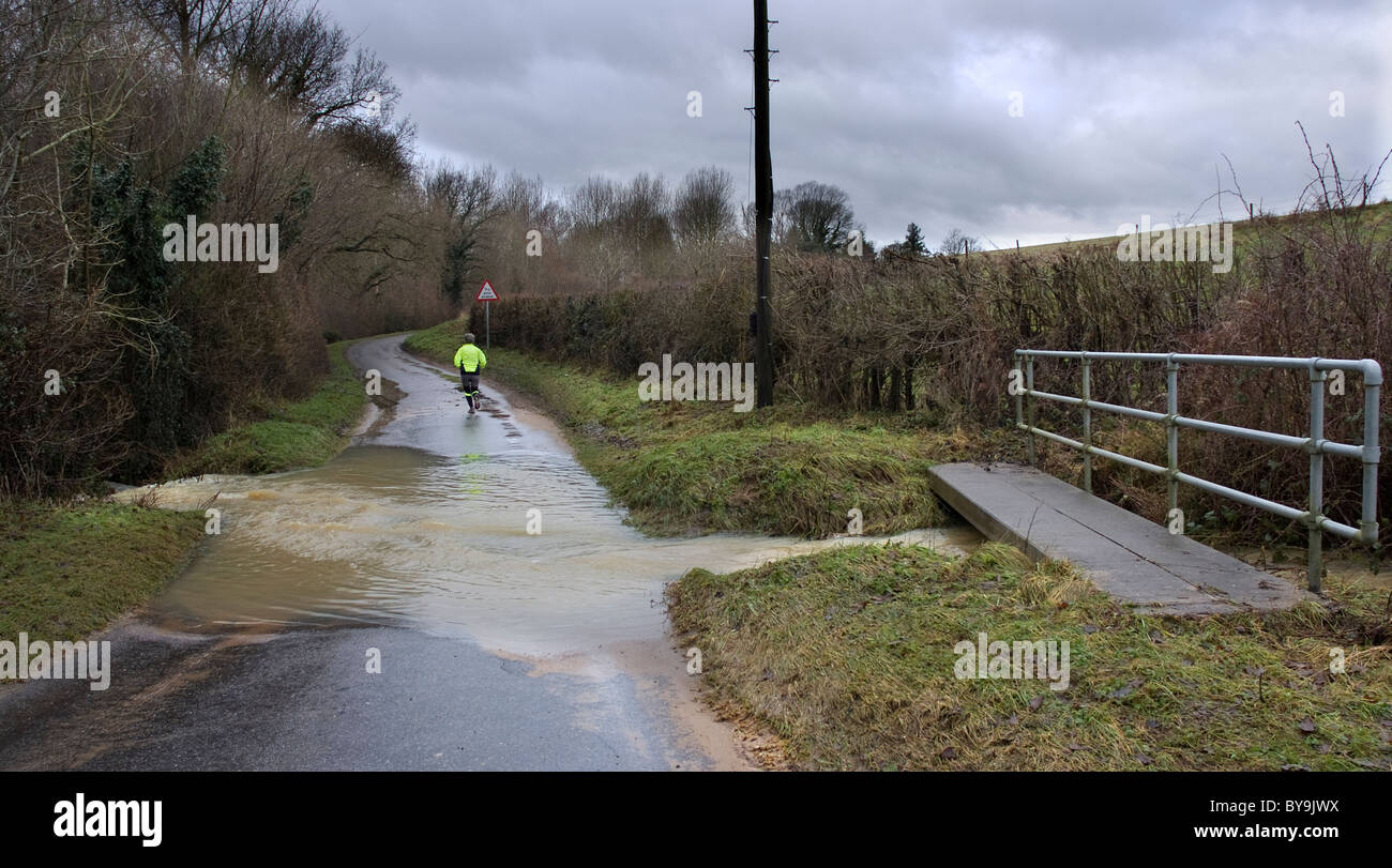woman running on flooded country road at broome norfolk uk Stock Photo ...