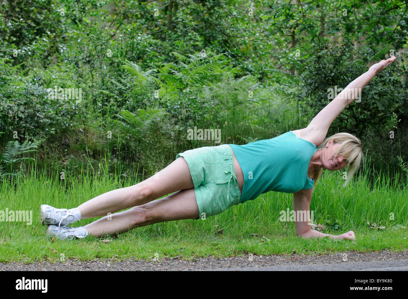 Female taking healthy exercise in the countryside Keep fit exercises ...