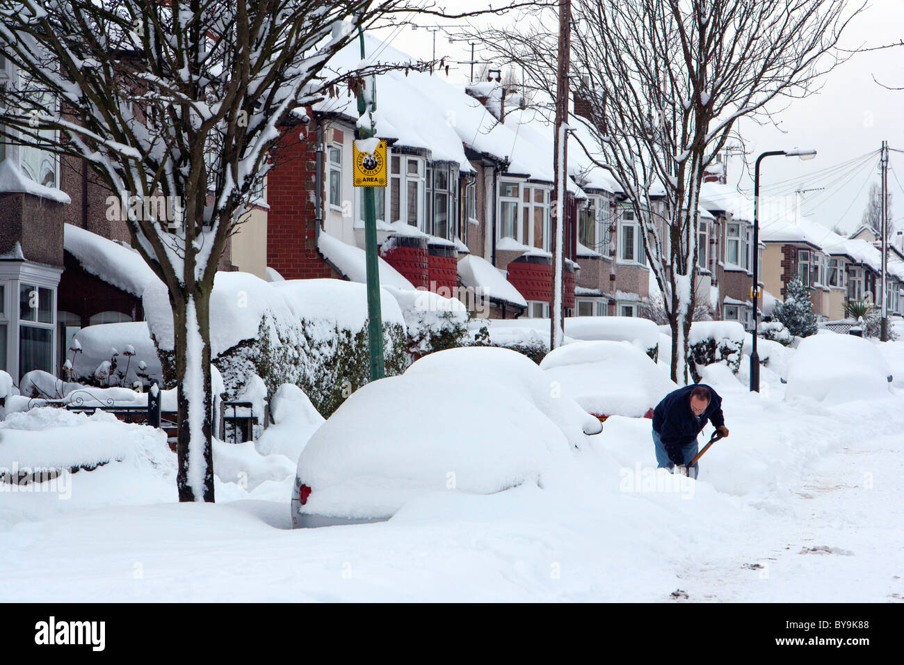 Heavy snow with man digging out car Stock Photo - Alamy