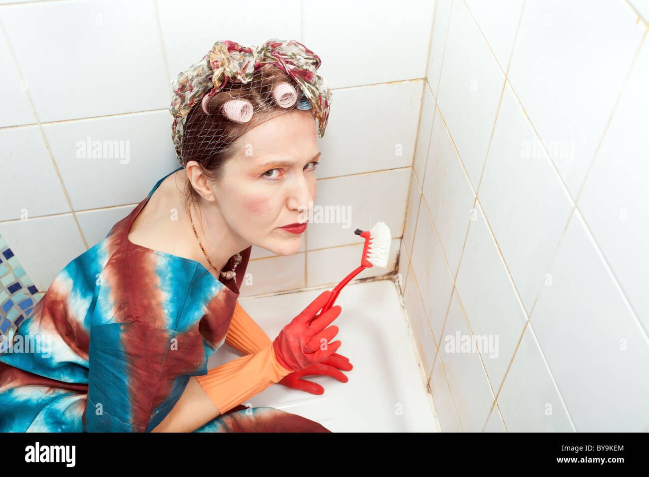 funny angry woman making a face while cleaning bathroom tiles Stock ...