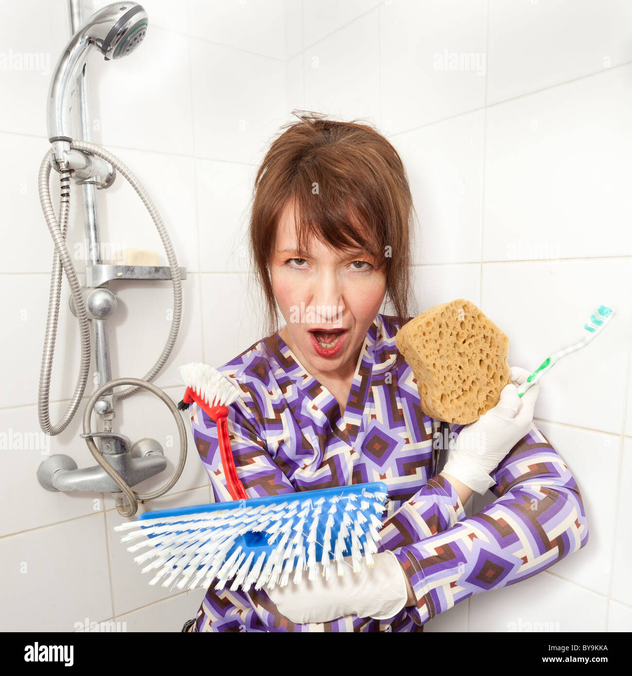 funny woman holding brushes ready to wash bathroom shower Stock Photo ...