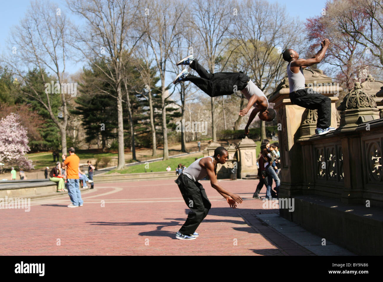 A traceur does a backflip in a park Stock Photo - Alamy