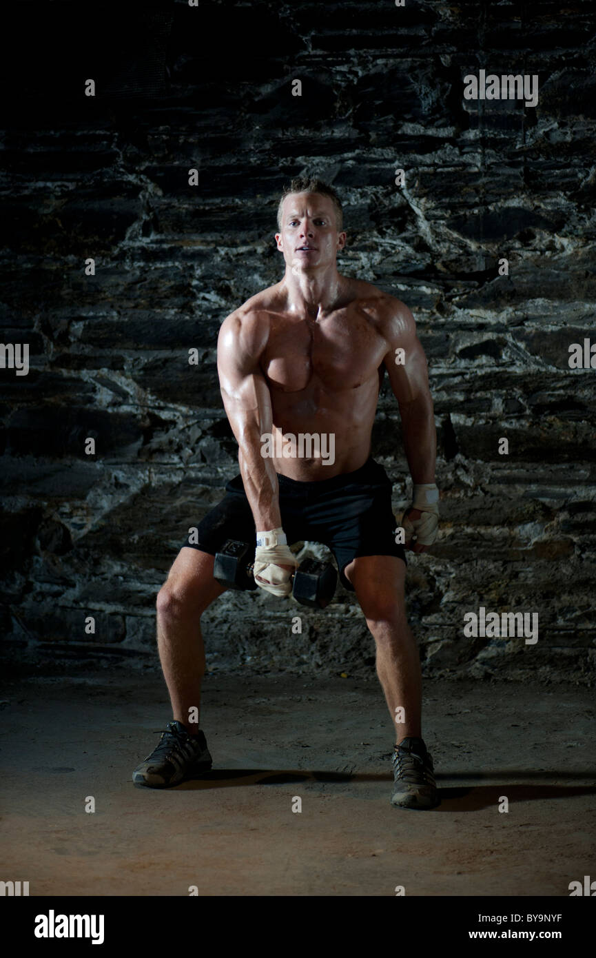 A male in incredible shape strengthening with weight training Stock ...