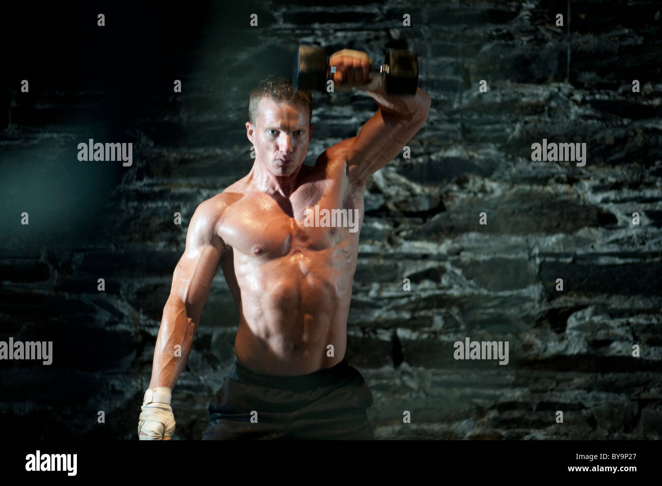 A male in incredible shape strengthening with weight training Stock ...