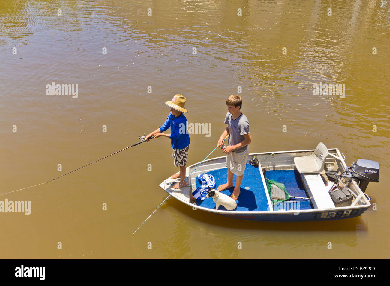 Boys fishing from a small boat Stock Photo - Alamy