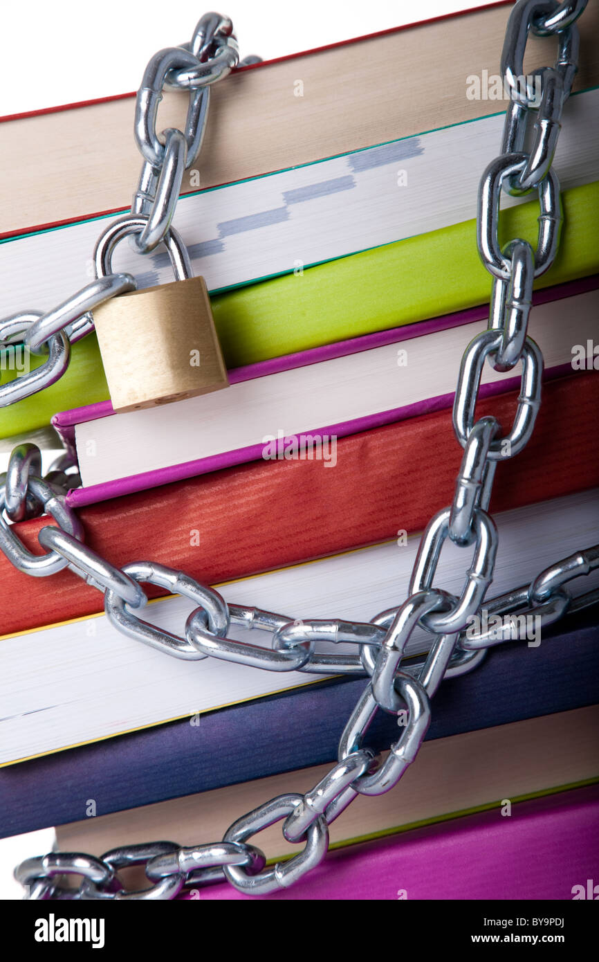 stack of colorful books protected with a chain (over a white background ...