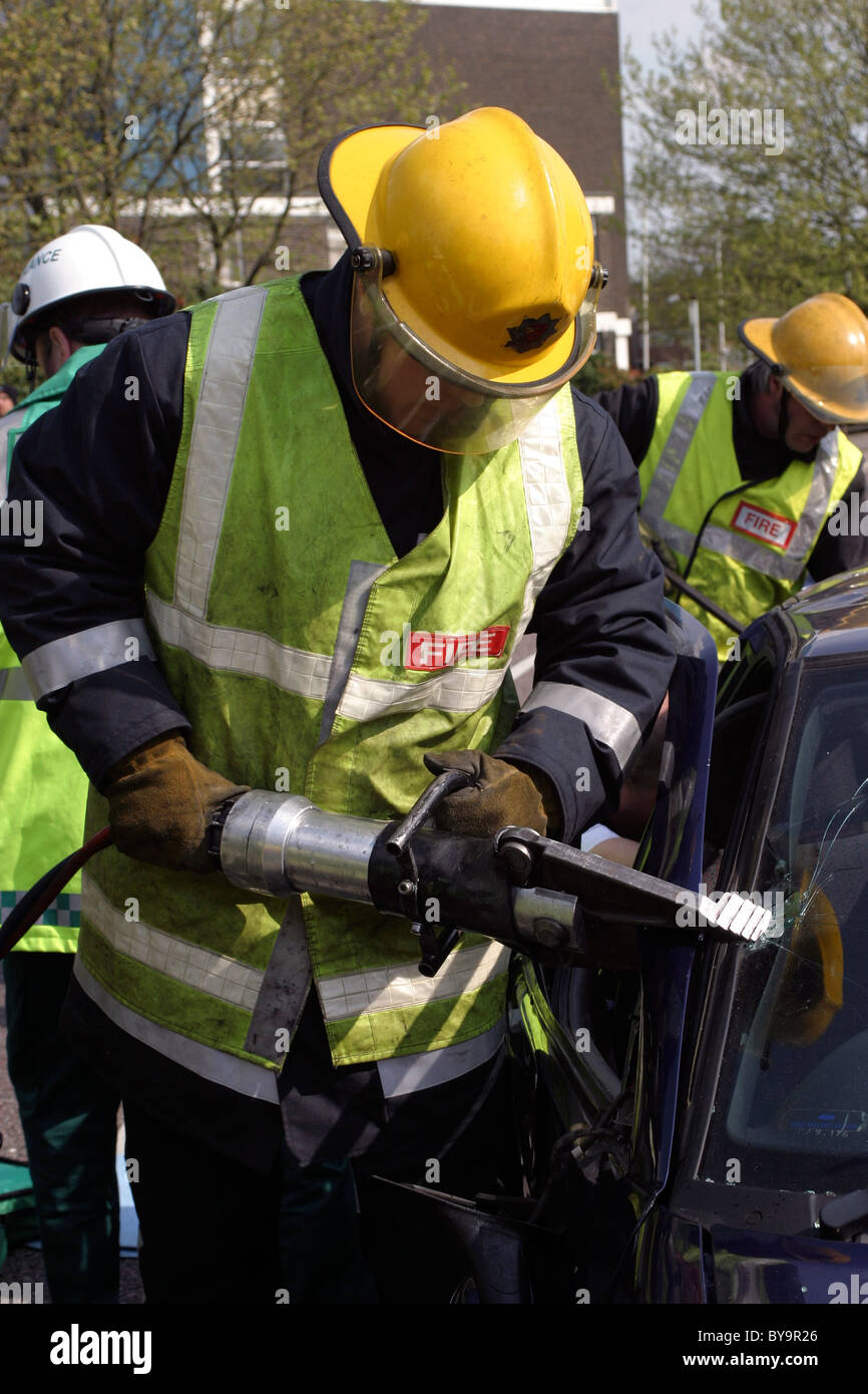 Firemen using rescue tools at a crash scene Stock Photo - Alamy
