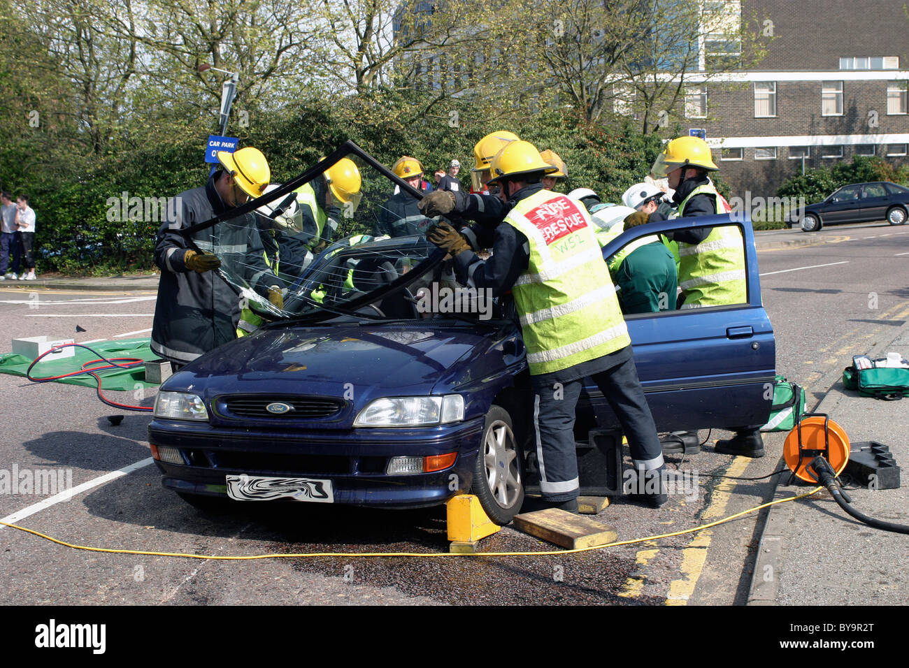 Firemen using rescue tools Stock Photo - Alamy