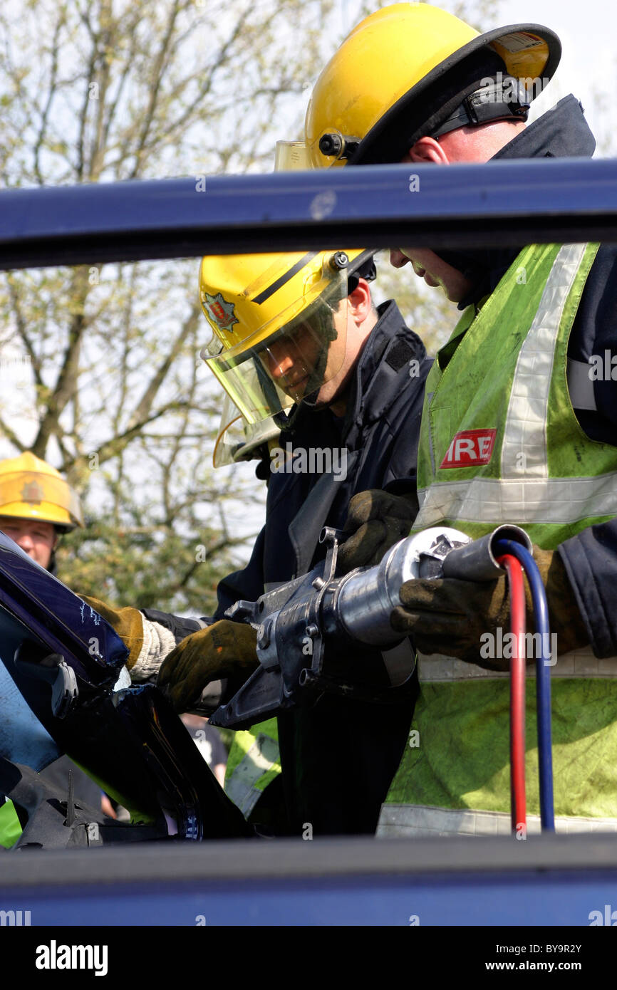 Fireman using cutting equipment Stock Photo - Alamy