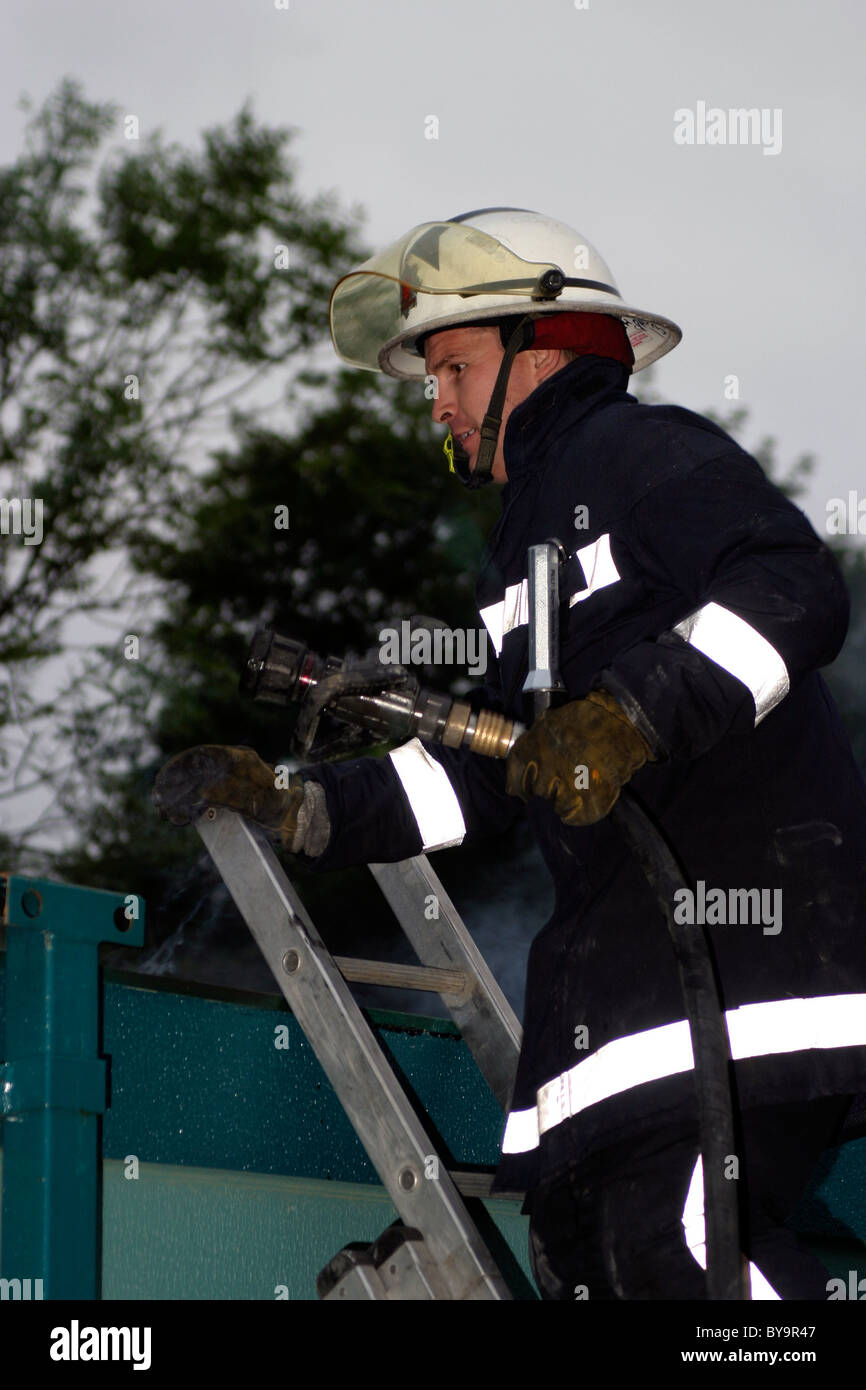 Fireman at the top of a ladder Stock Photo - Alamy