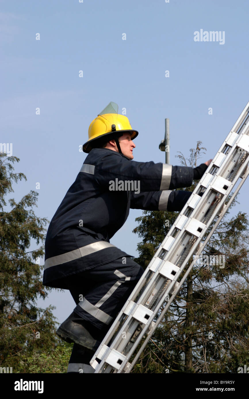 Firefighter climbs a ladder Stock Photo - Alamy