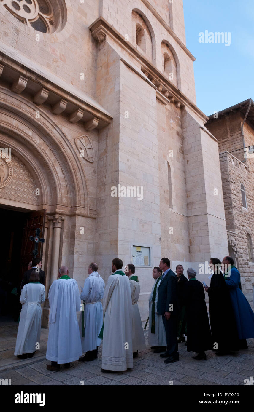 Group of priests entering the church of the redeemer in procession ...