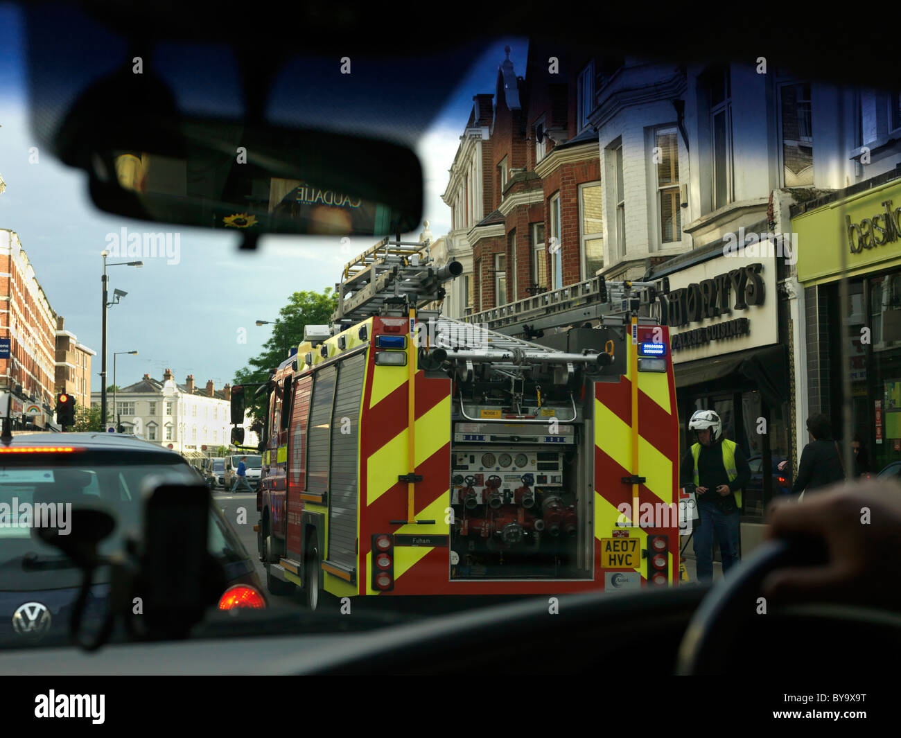 Fire Engine Stopped On Busy Road At Traffic Lights England Stock Photo ...