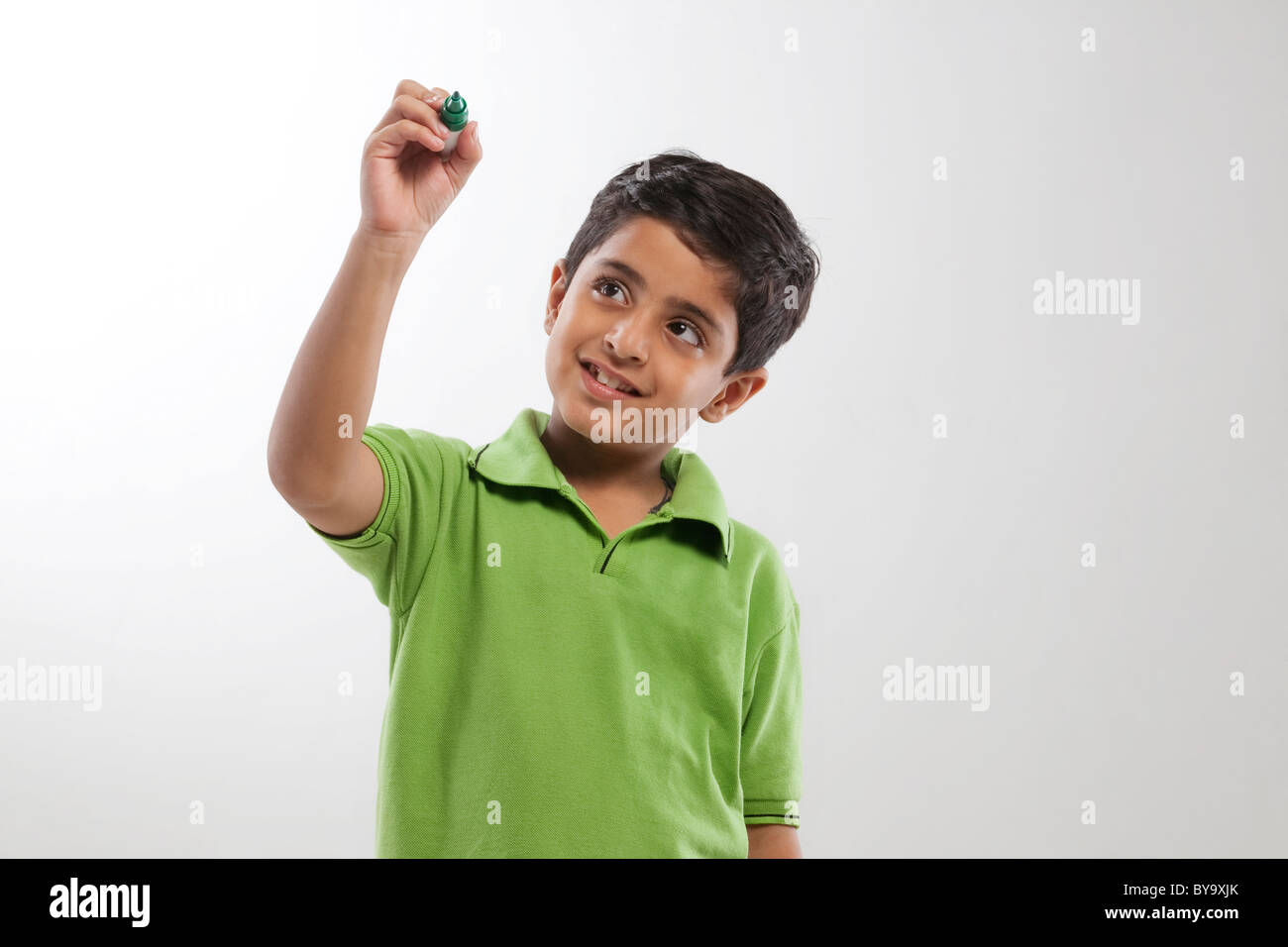 Young boy pretending to write with a marker pen Stock Photo - Alamy