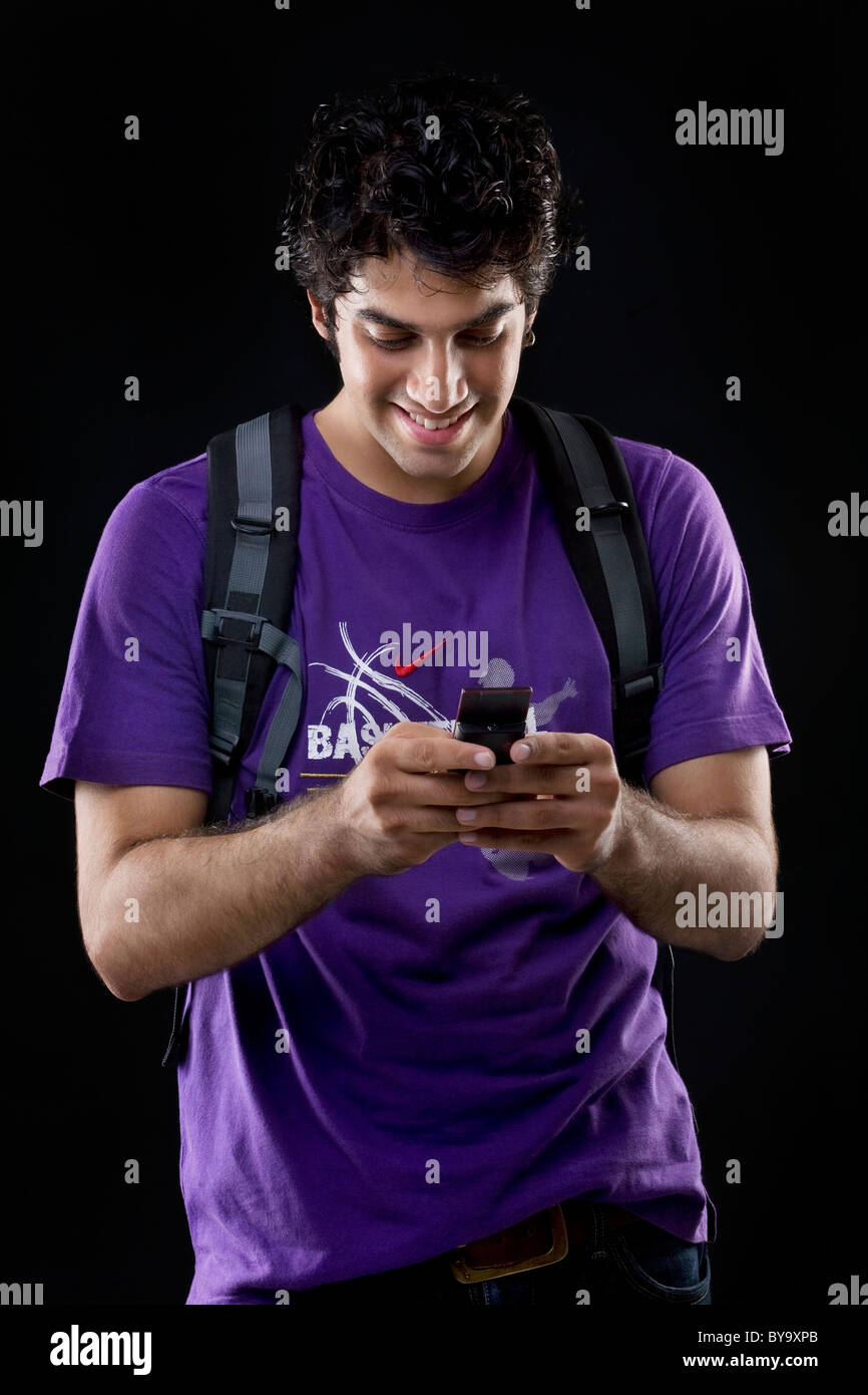 Young man sending a text message Stock Photo - Alamy