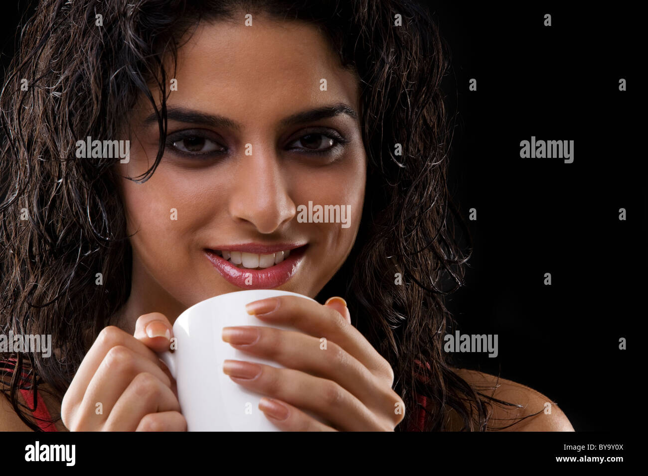 Close-up of a woman holding a mug Stock Photo - Alamy