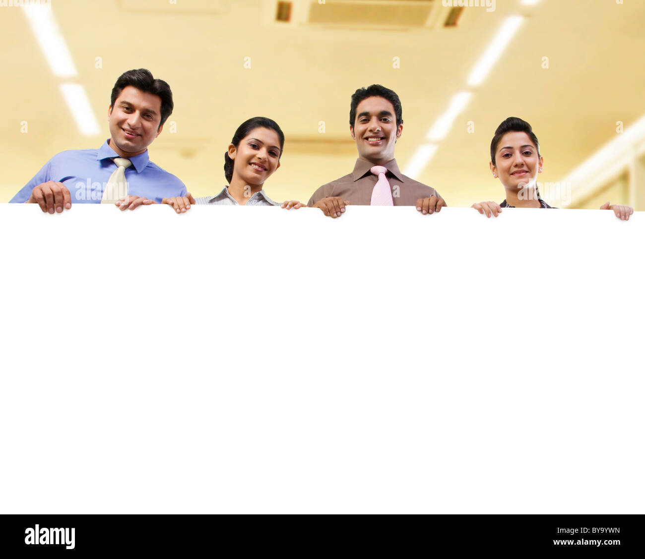 Businesspeople holding a placard Stock Photo - Alamy