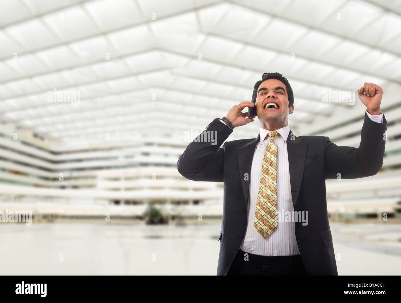 Businessman getting excited Stock Photo - Alamy