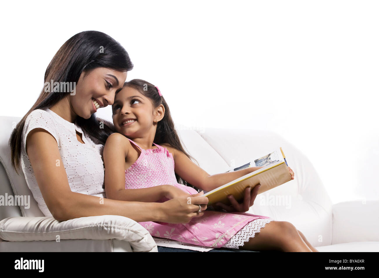 Mother and daughter with a story book Stock Photo - Alamy