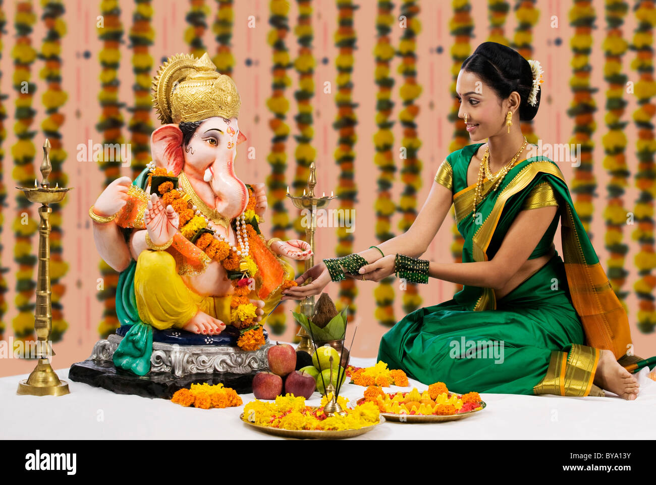 Woman performing a pooja Stock Photo - Alamy