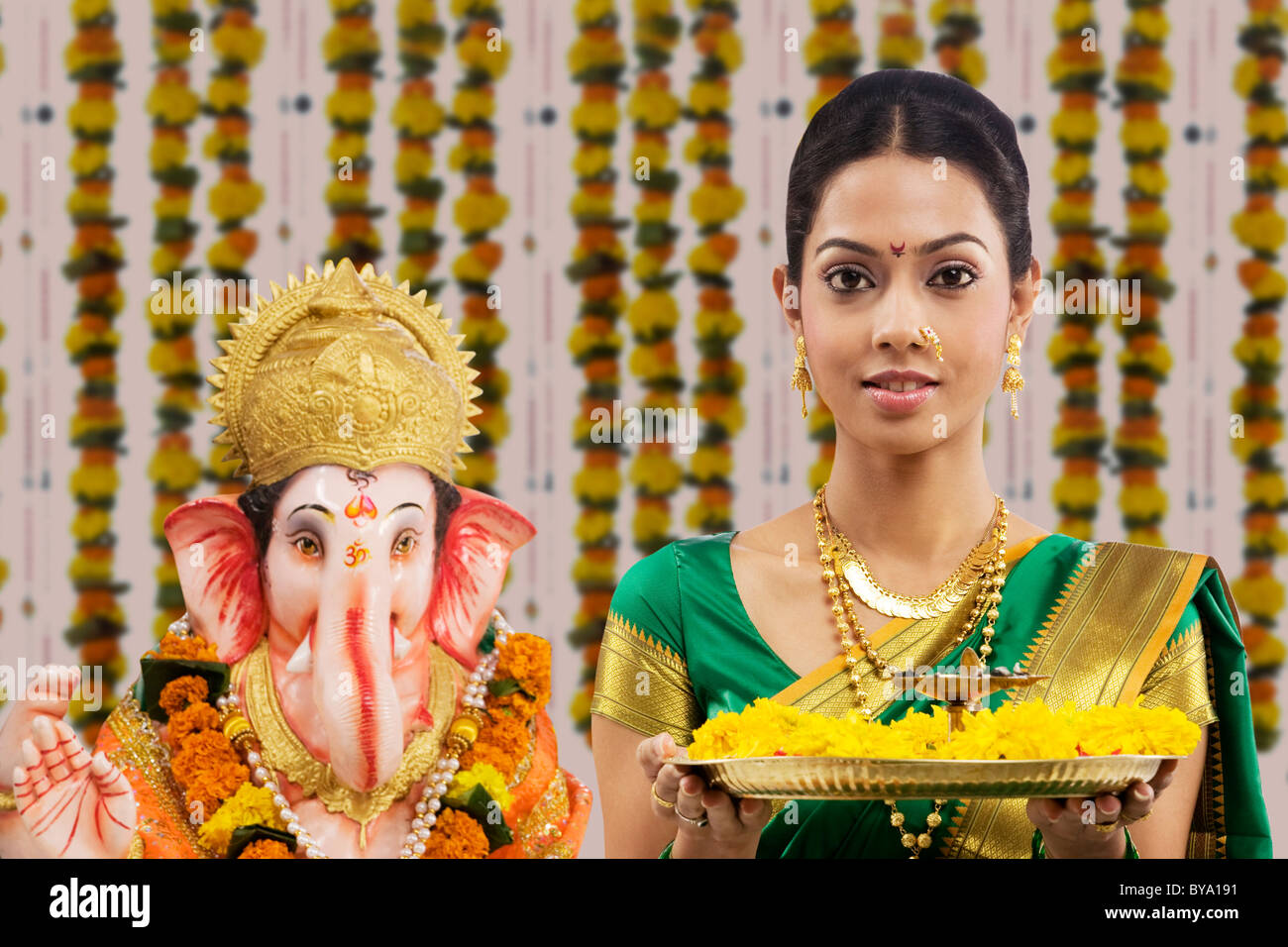 Portrait of a woman performing a pooja Stock Photo - Alamy