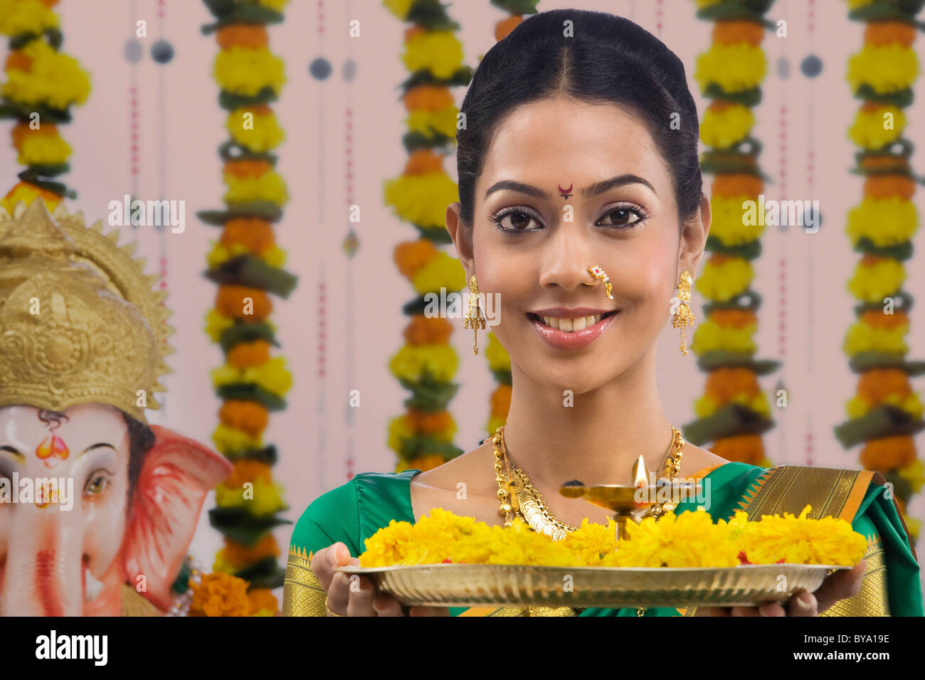 Portrait of a woman performing a pooja Stock Photo - Alamy