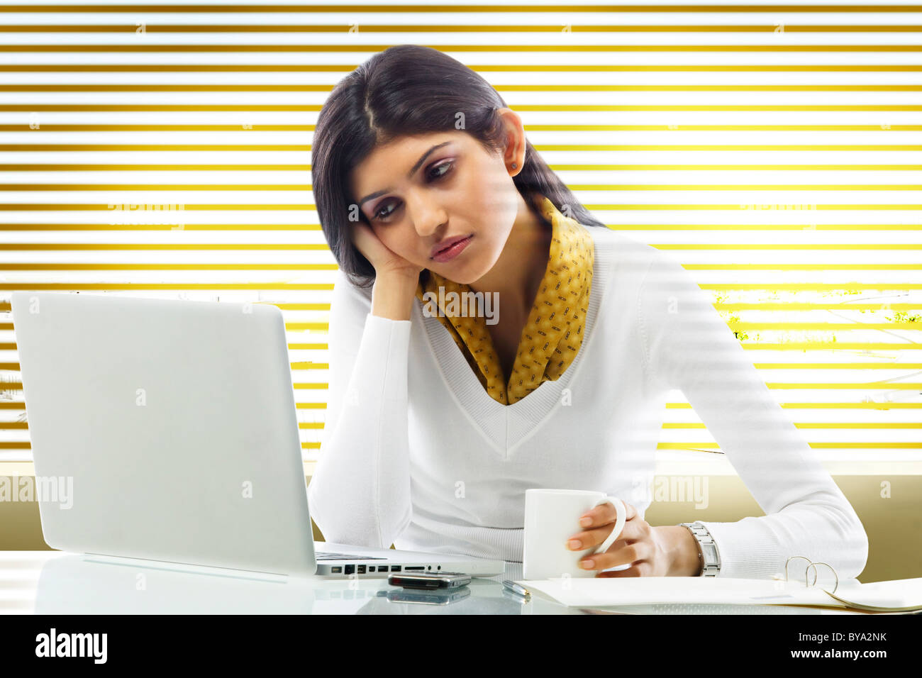 Businesswoman getting bored in an office Stock Photo - Alamy