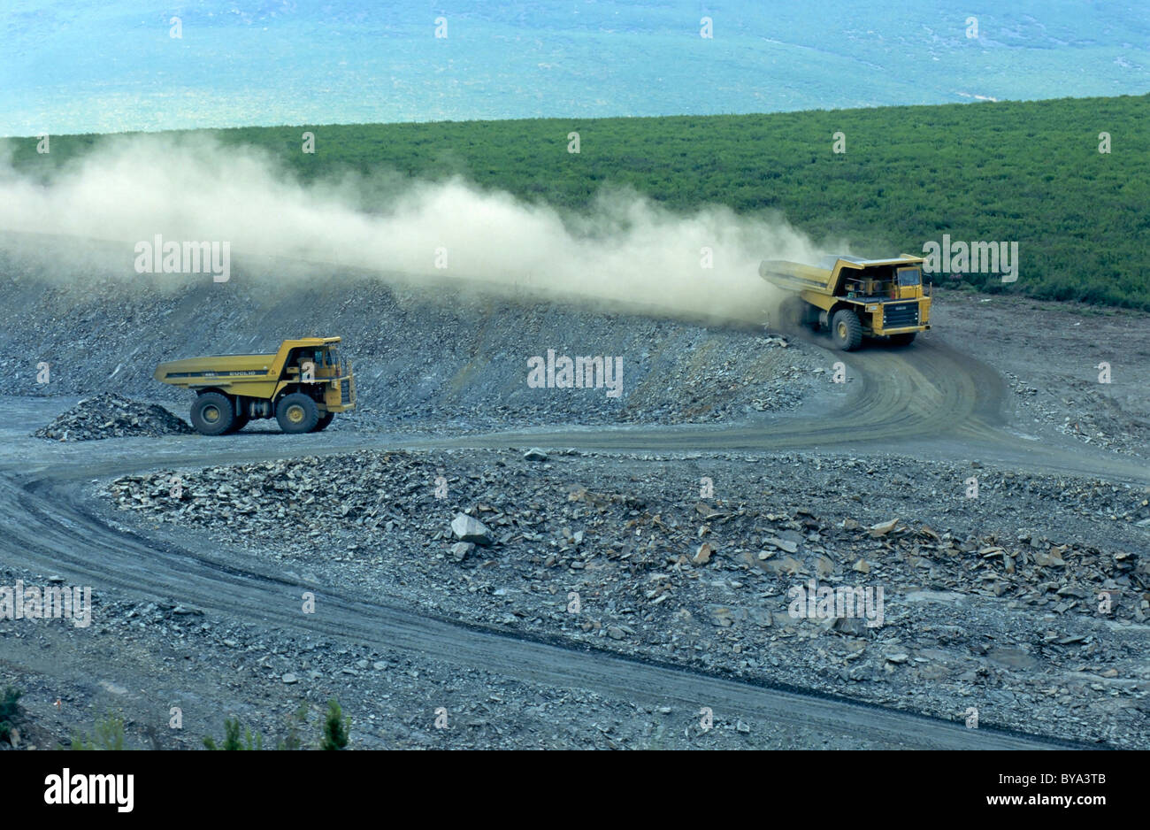 Billowing dust follows a dump truck in a quarry Stock Photo - Alamy
