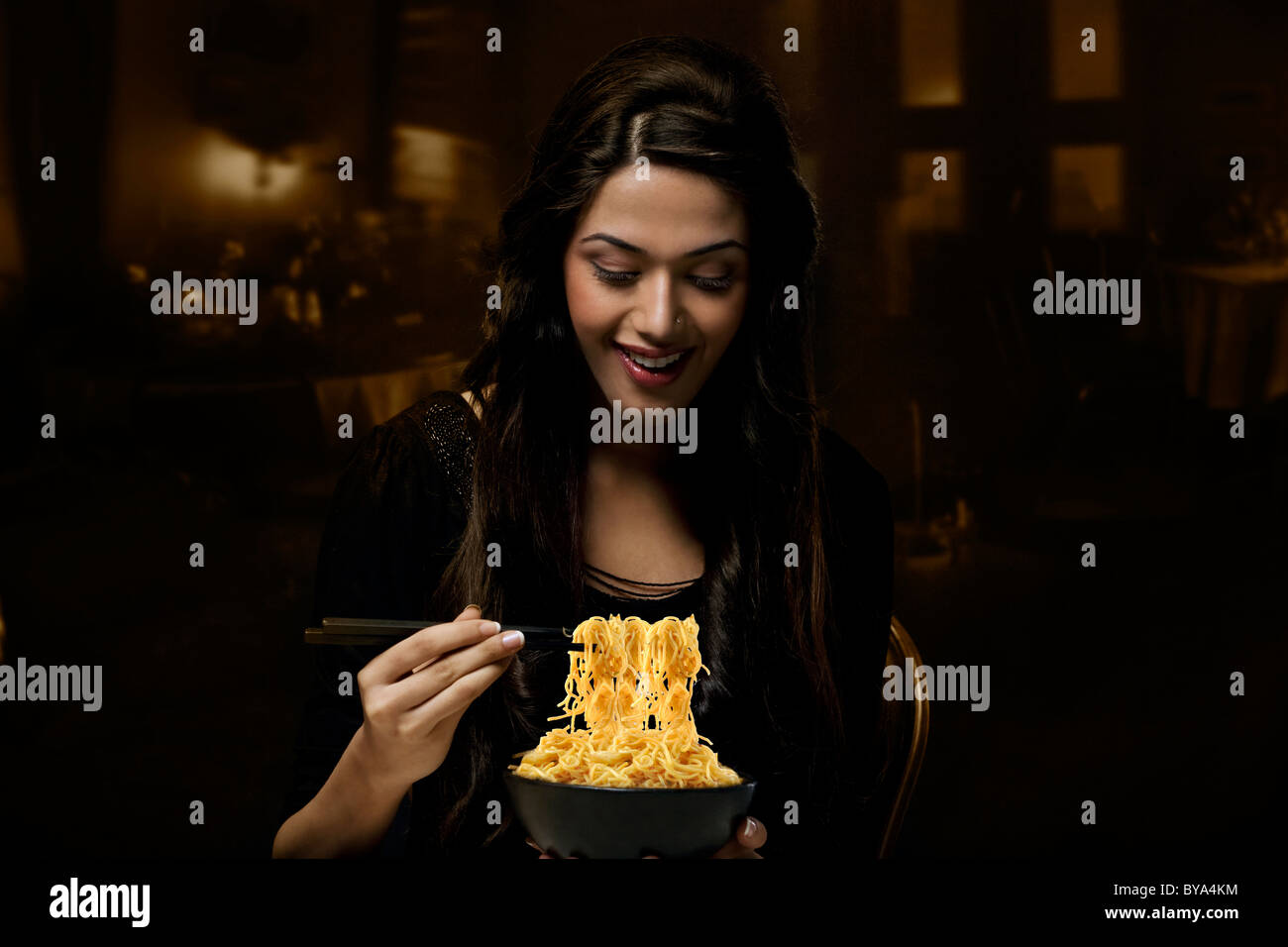 Young girl with a bowl of noodles Stock Photo - Alamy
