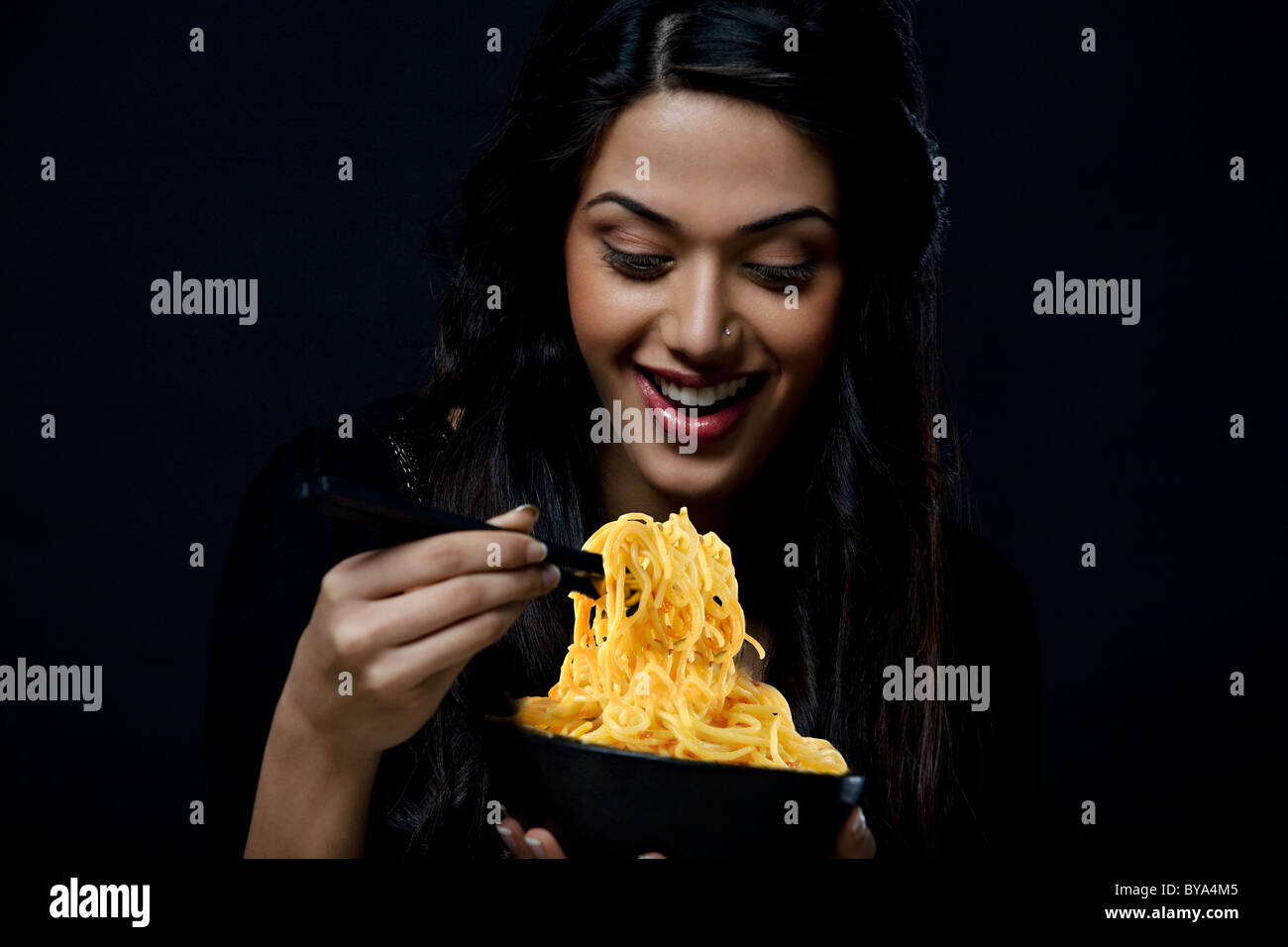 Indian girl eating noodles hi-res stock photography and images - Alamy