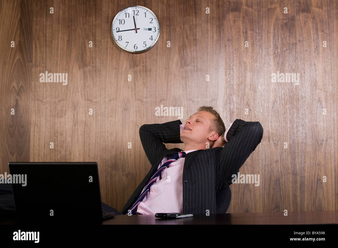 Business man at desk relaxing Stock Photo - Alamy