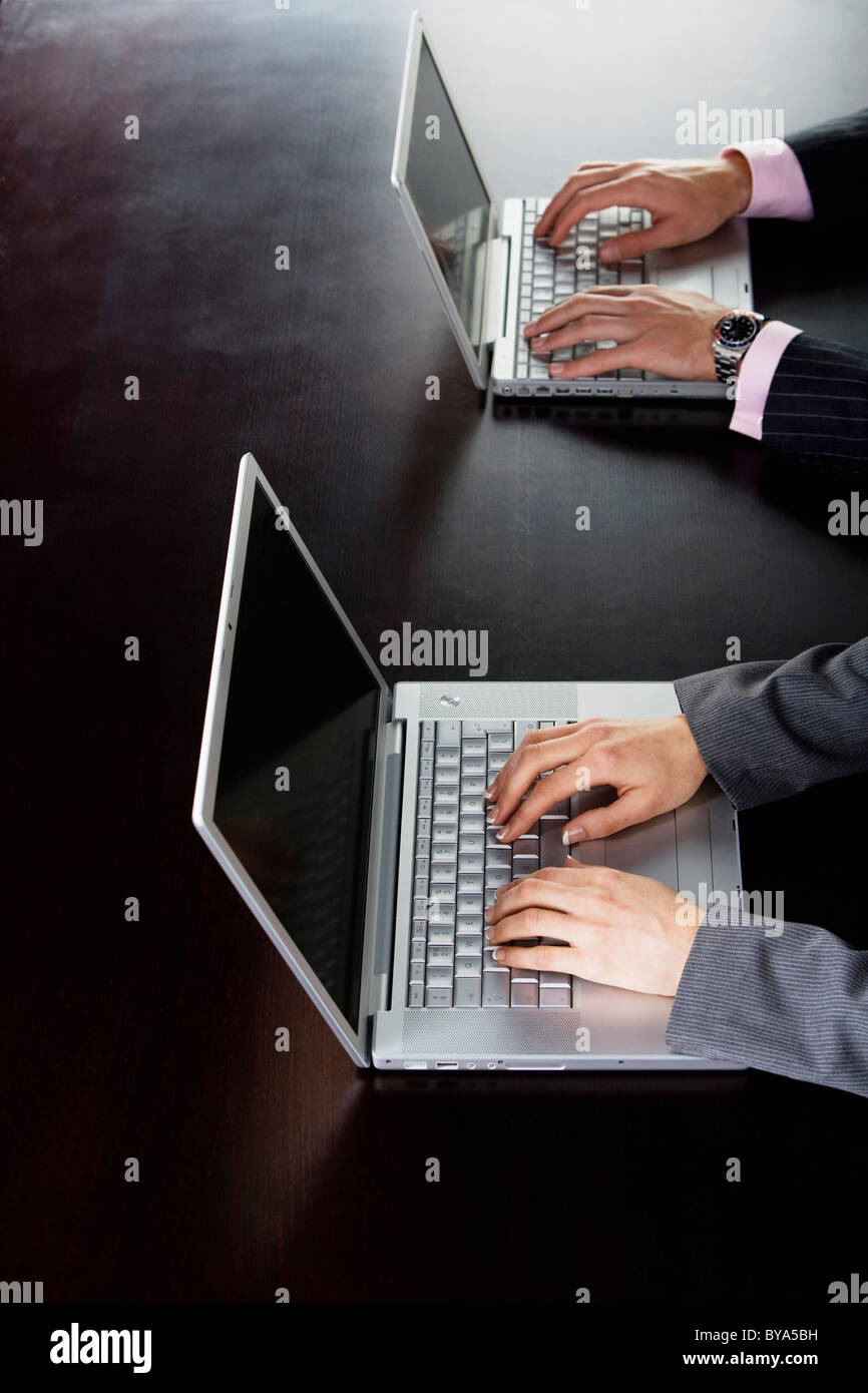 Business man and woman on computers Stock Photo - Alamy