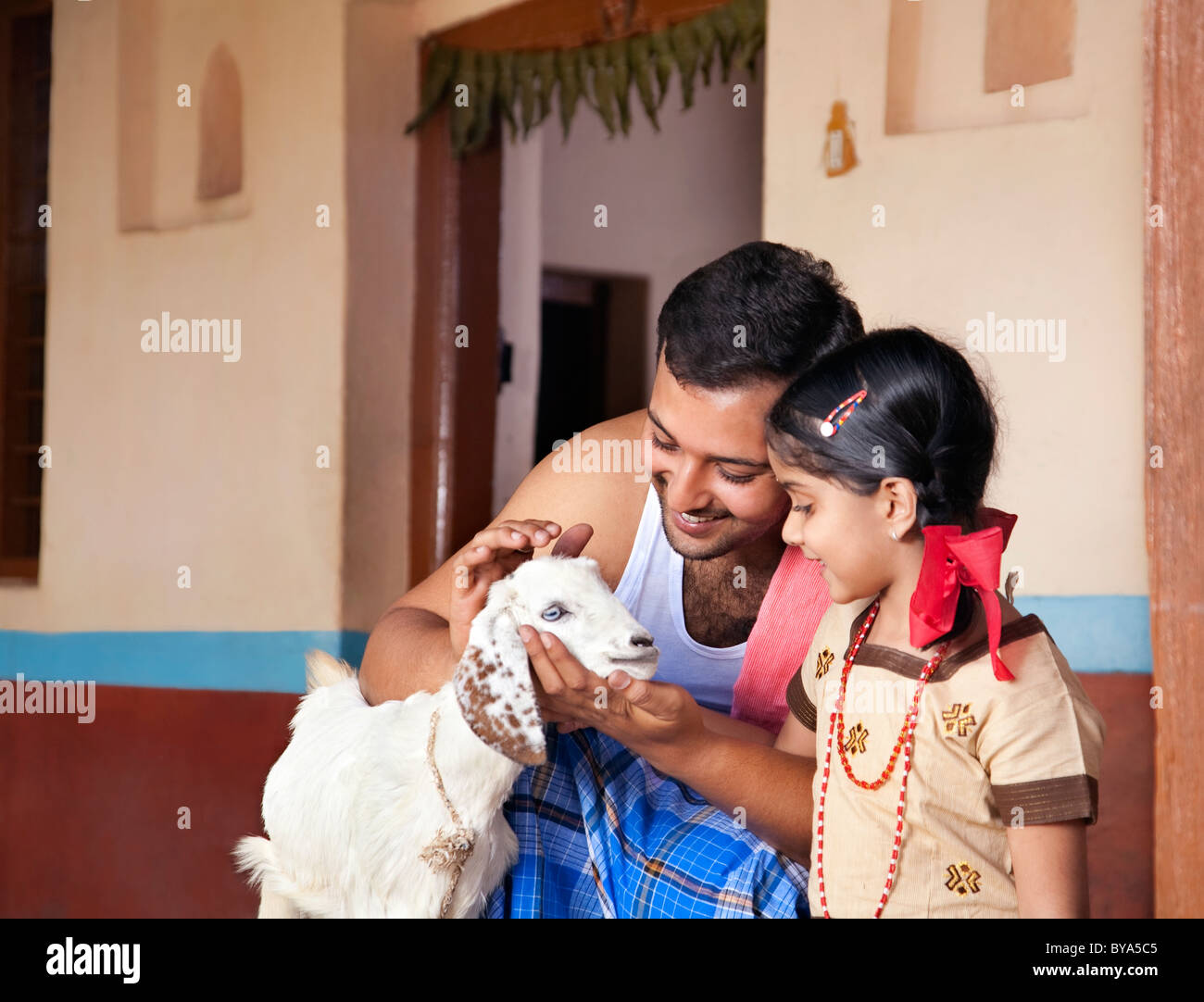 Father showing a goat to his daughter Stock Photo - Alamy