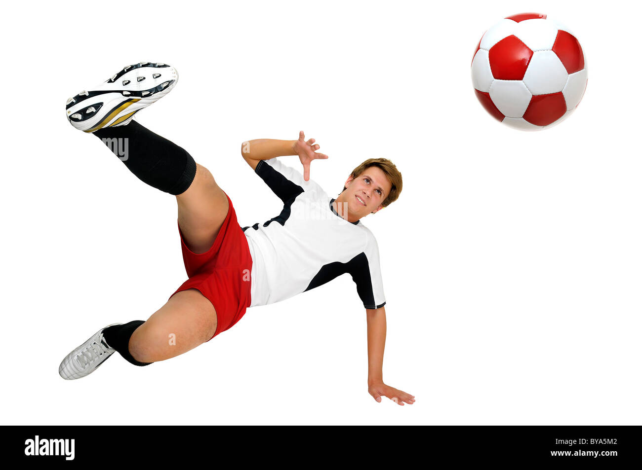 Young football player with a ball isolated in white Stock Photo - Alamy