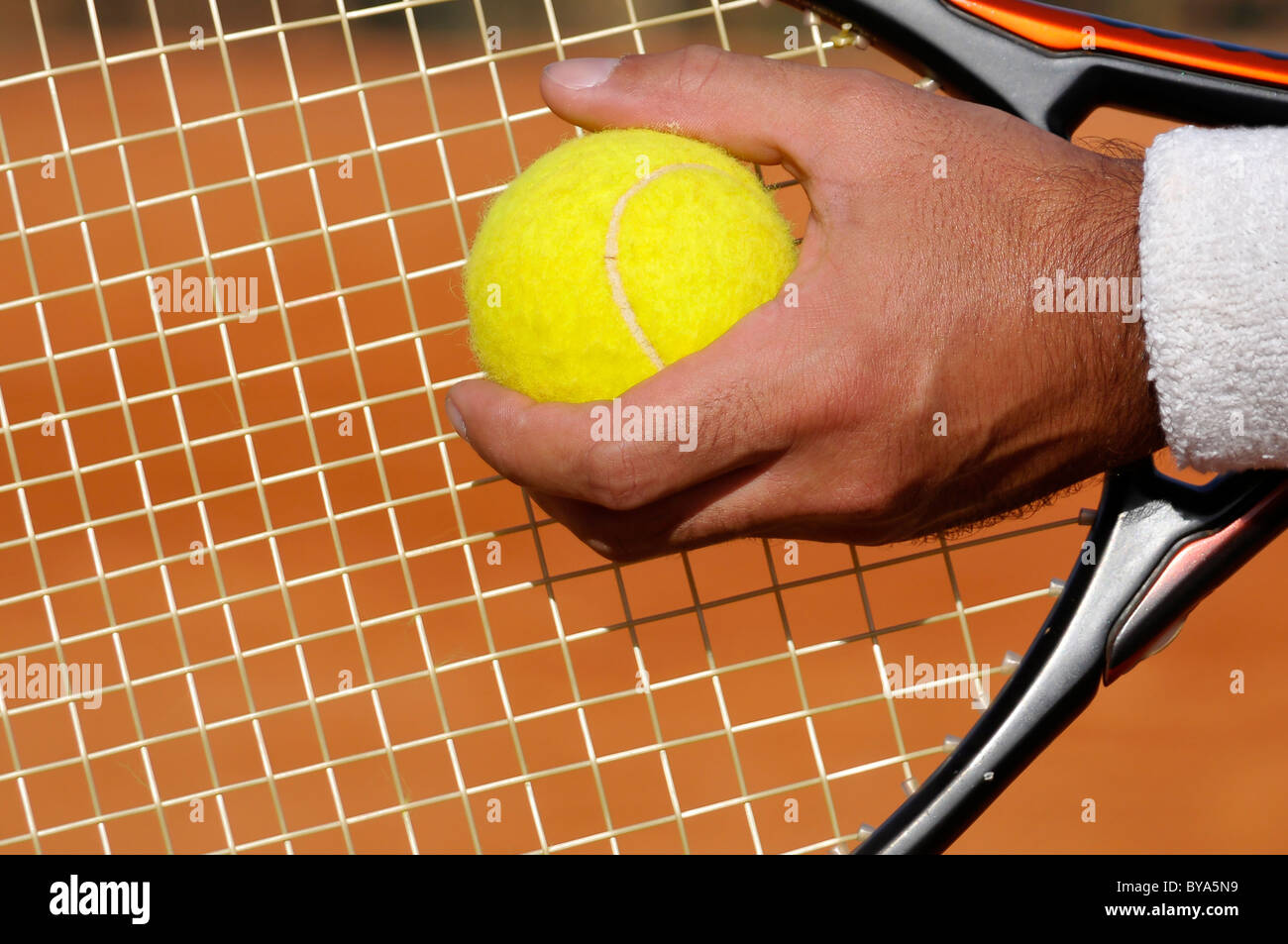 Player's hand with tennis ball preparing to serve Stock Photo - Alamy