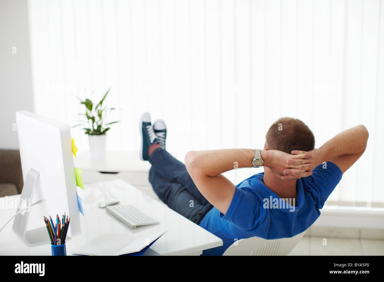 Businessman reclining on chair hi-res stock photography and images - Alamy
