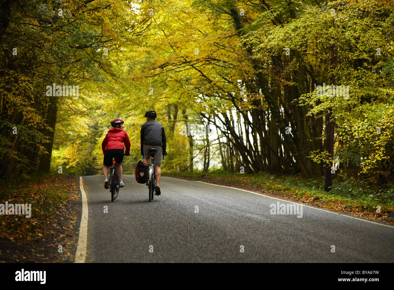 Woman cycling down on road hi-res stock photography and images - Alamy