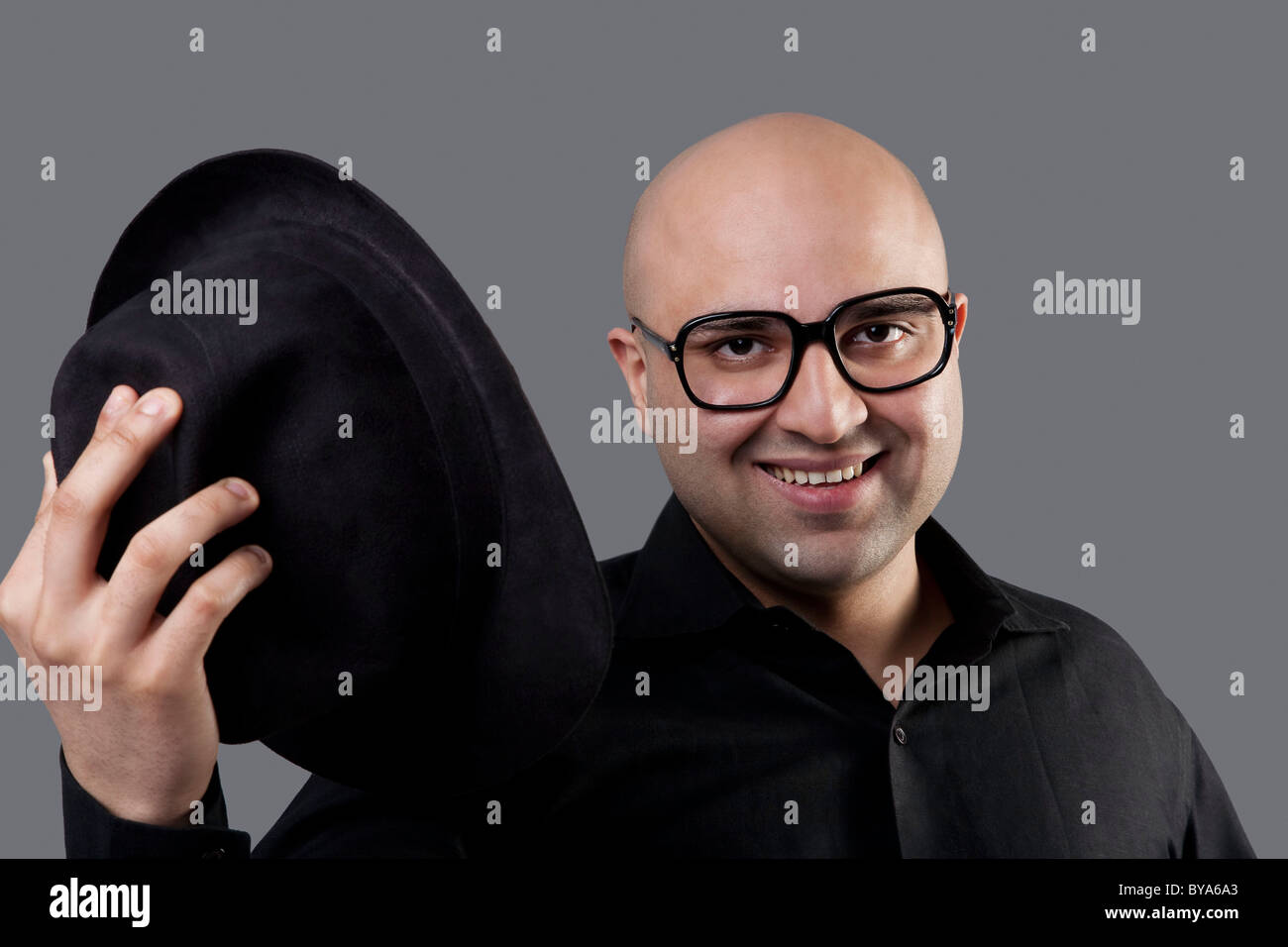 Bald man taking off his hat Stock Photo - Alamy
